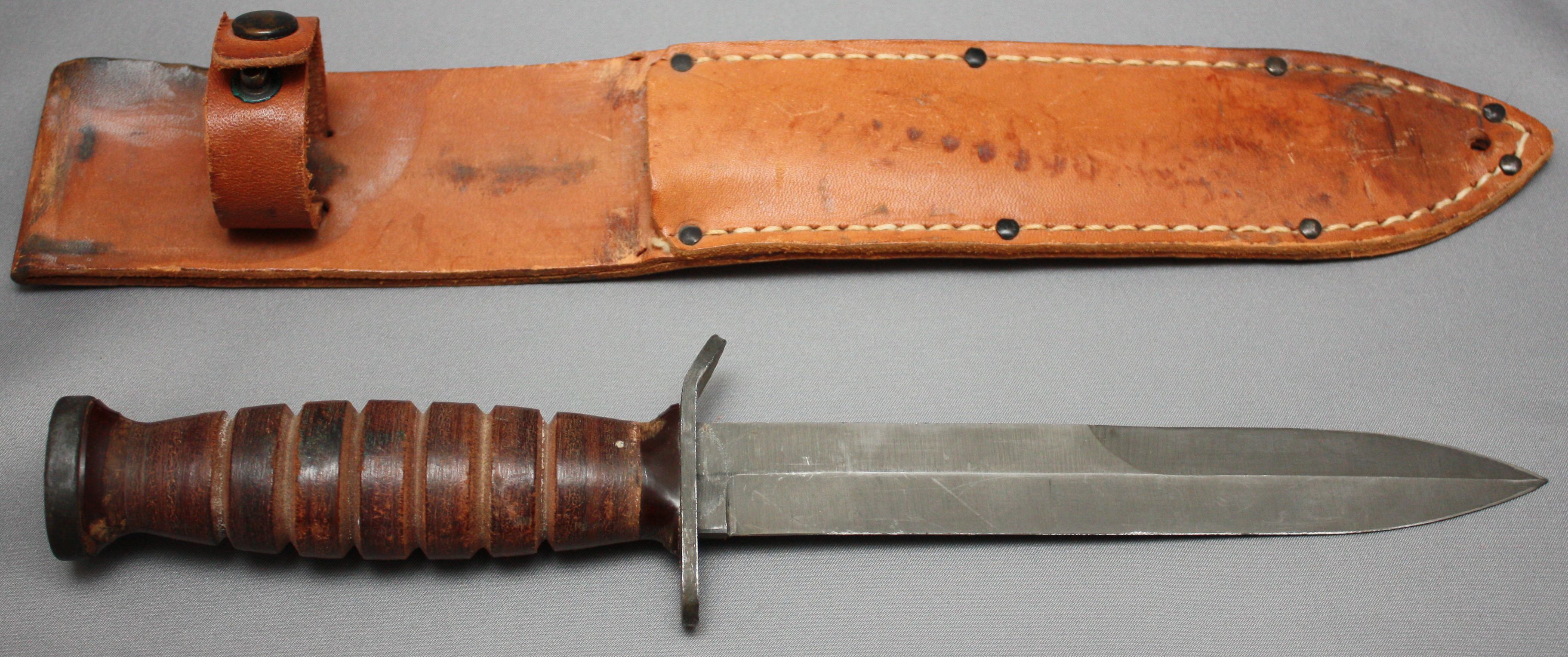 Unmarked M3 trench knife with commercial leather sheath.